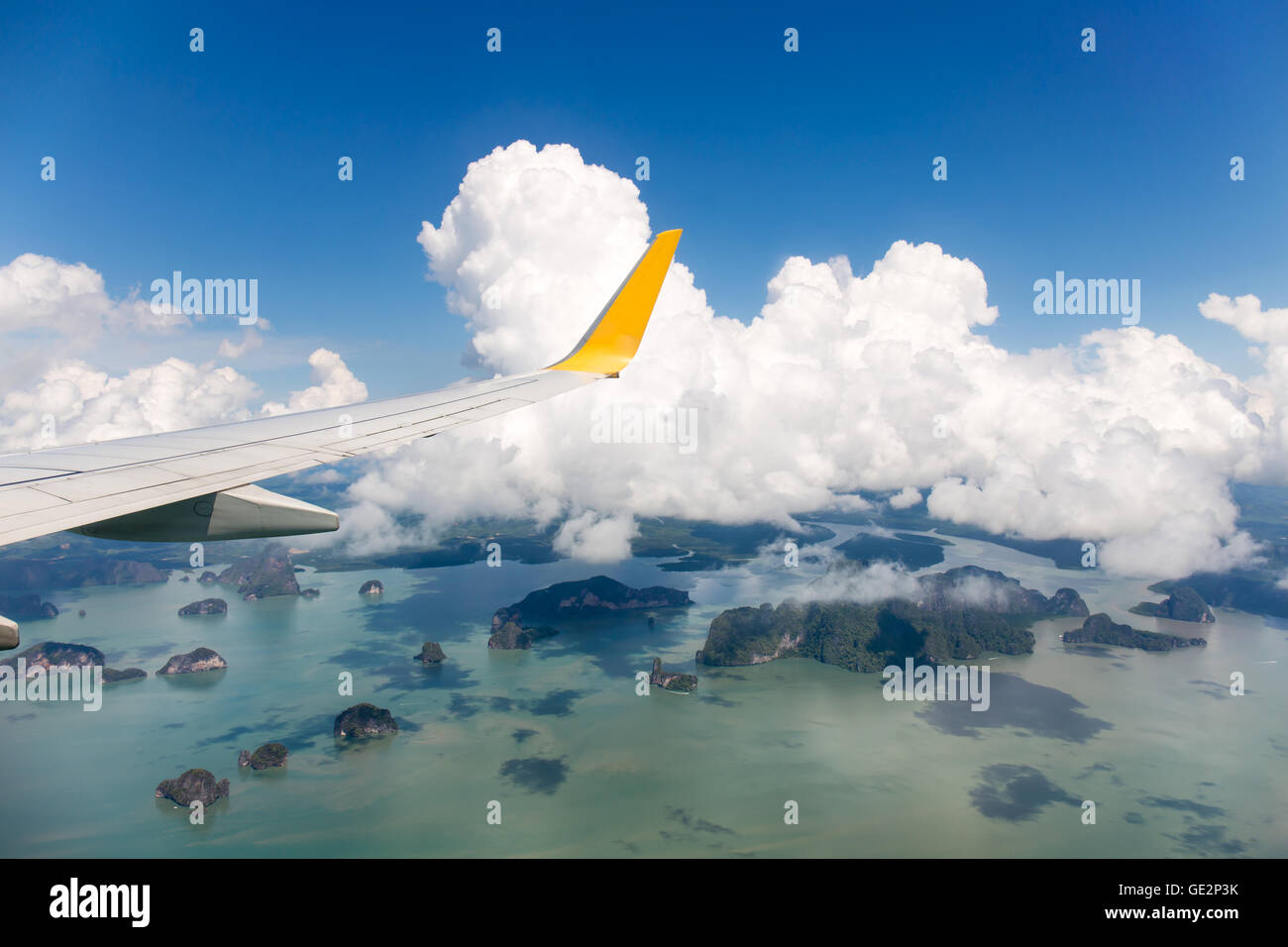 Wing of the plane with blue sky and cloud over island sea Stock Photo ...