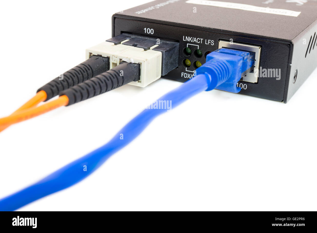 Close up fiber media converter and cables on white isolated background ...