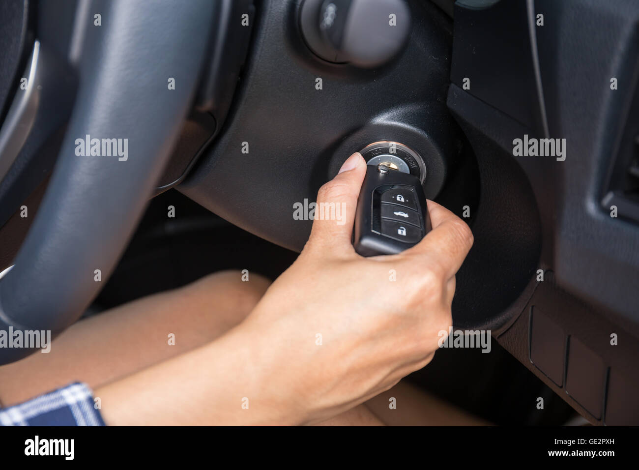 Women driver hand inserting car key and starting engine Stock Photo - Alamy