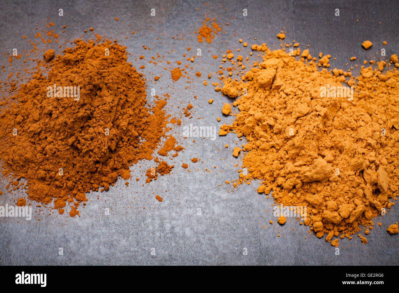 Cocoa and carob powder heap on blck stone background Stock Photo - Alamy