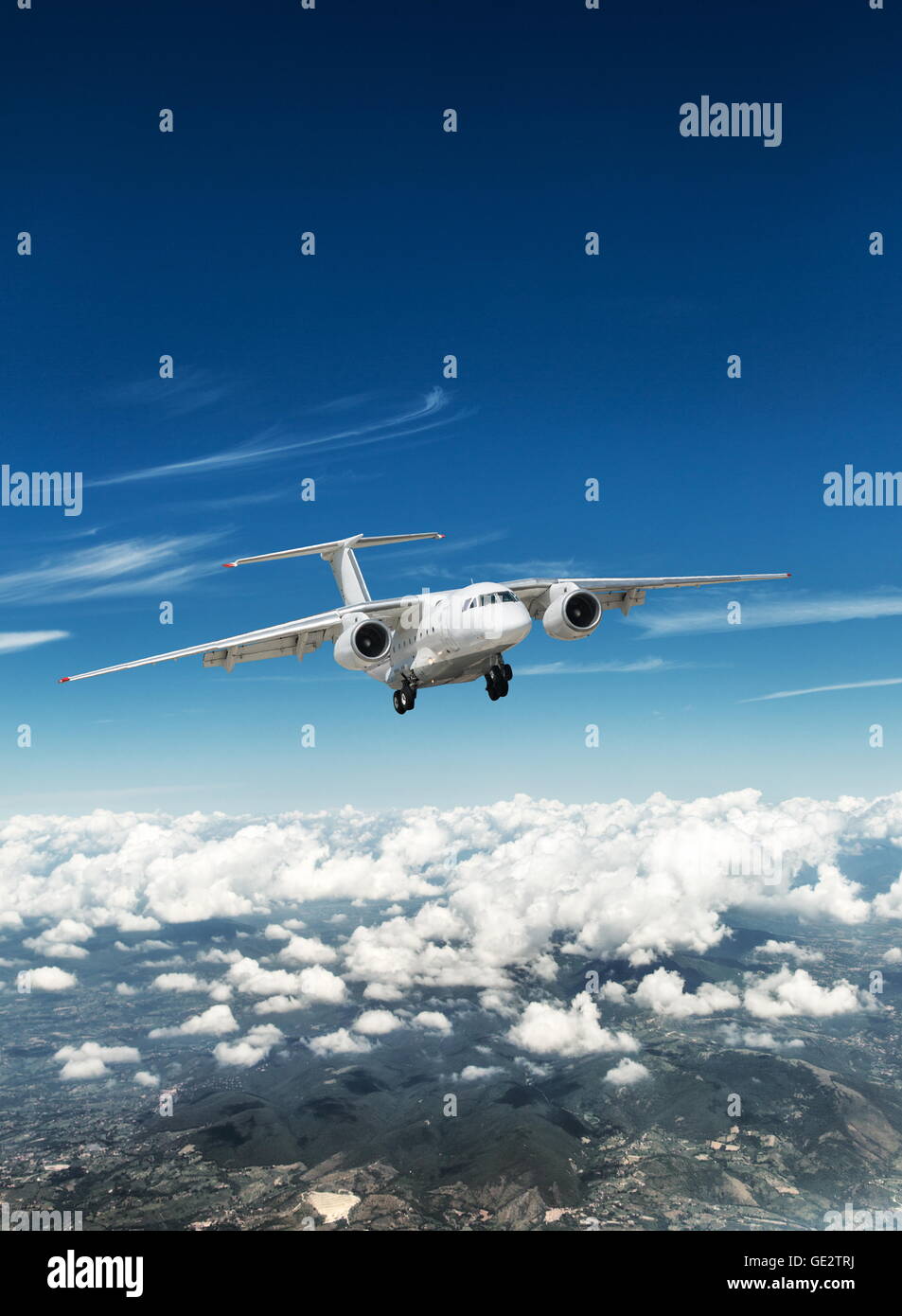 Airplane over the clouds Stock Photo - Alamy
