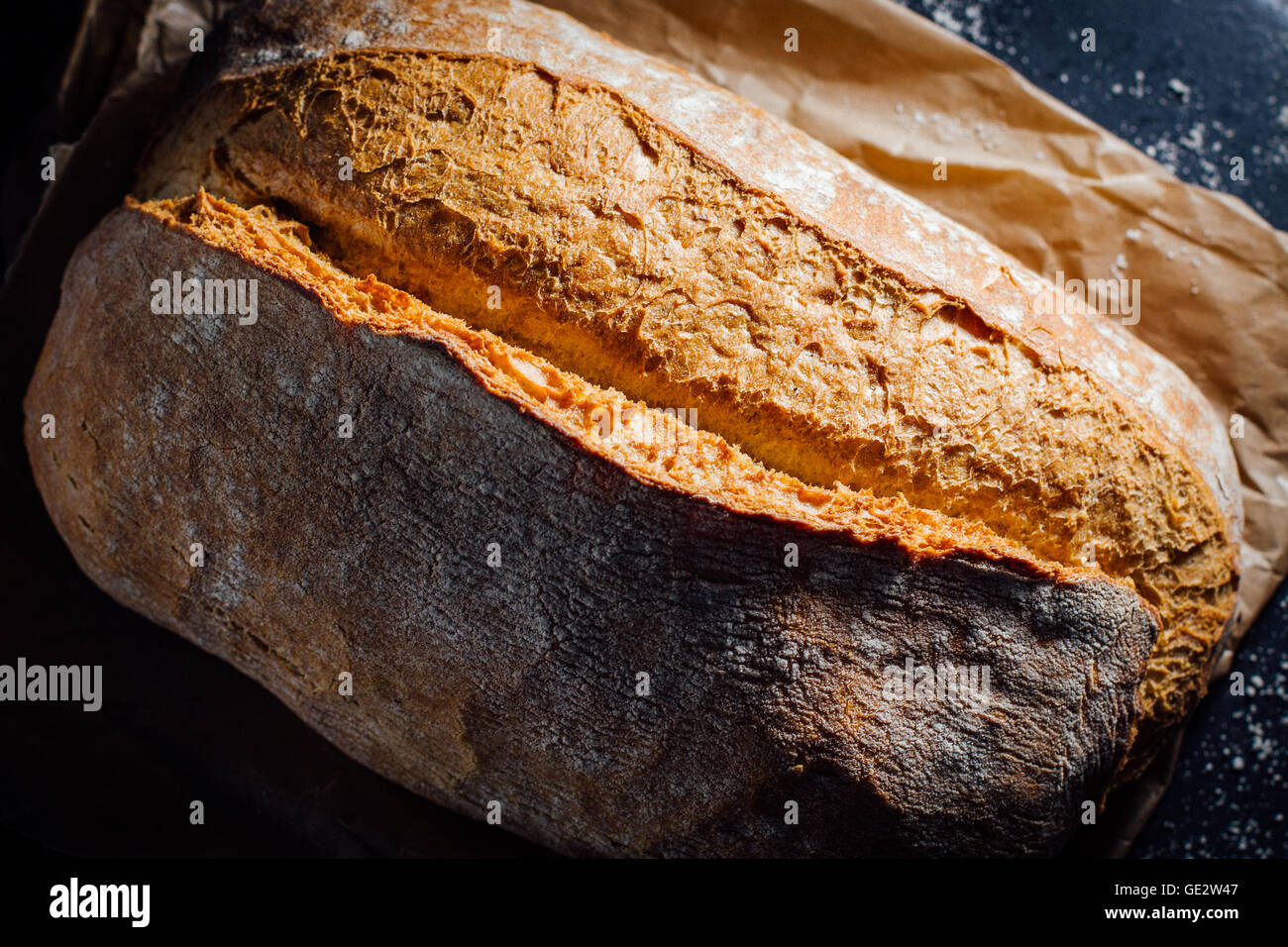 Fresh bread on roast paper in black stone background Stock Photo - Alamy
