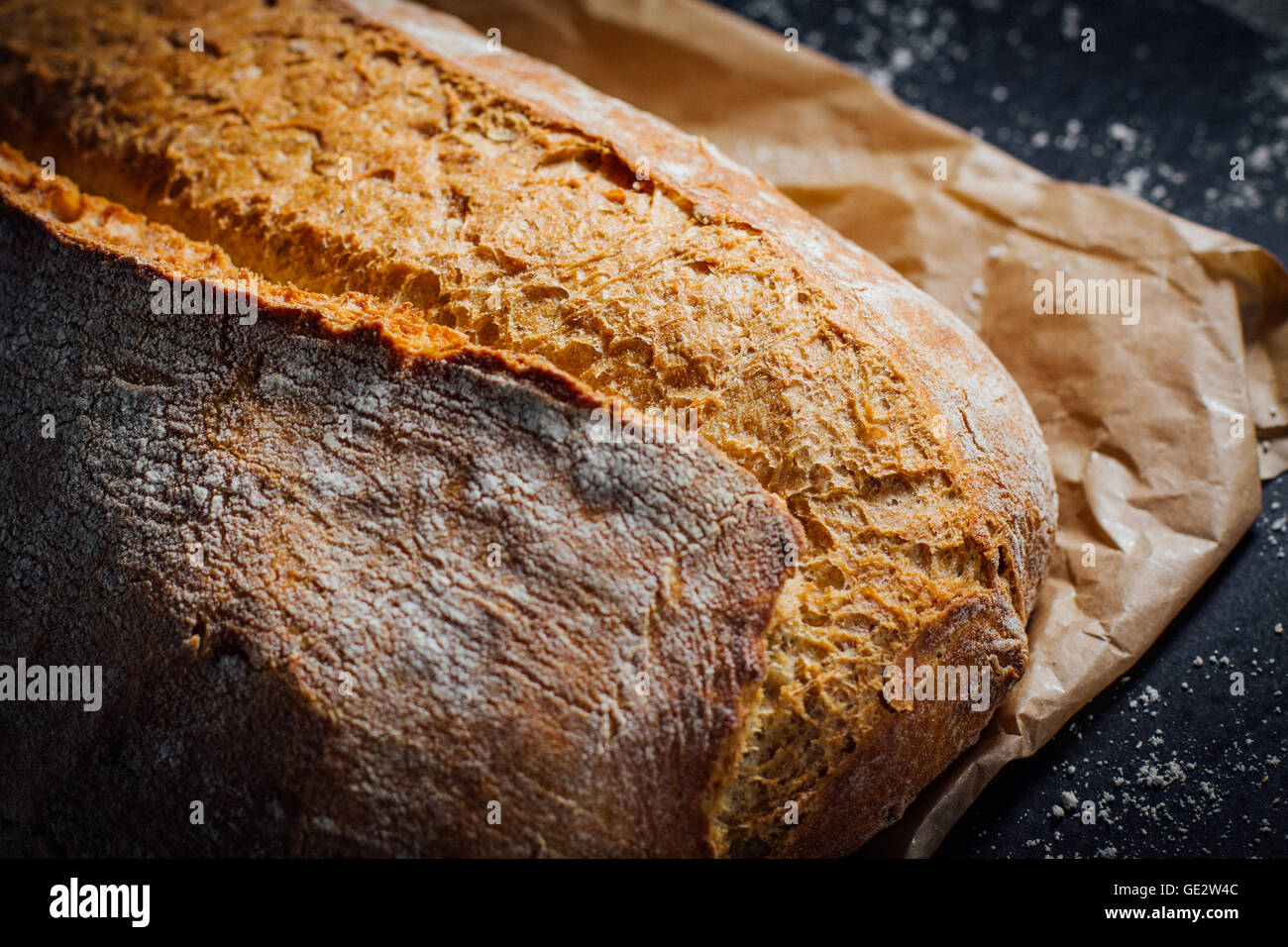 Fresh bread on roast paper in black stone background Stock Photo - Alamy