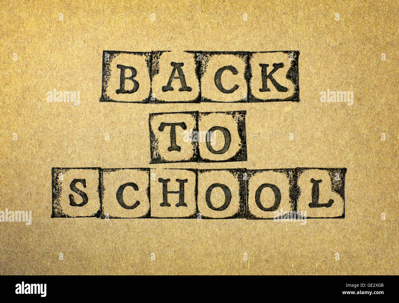 Words Back to school make by black alphabet stamps on cardboard Stock ...