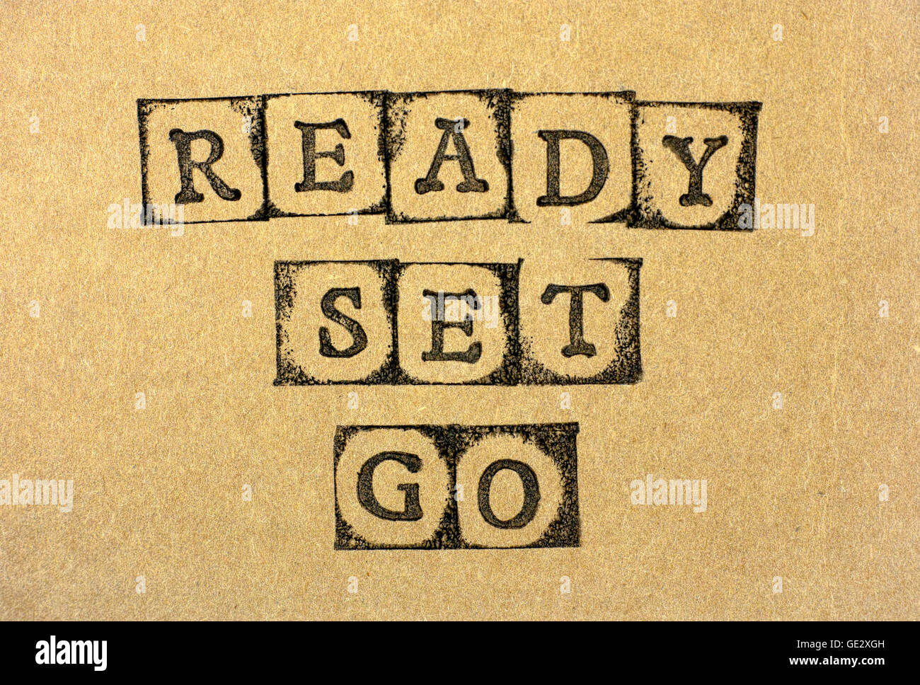 Words Ready Set Go make by black alphabet stamps on cardboard Stock ...
