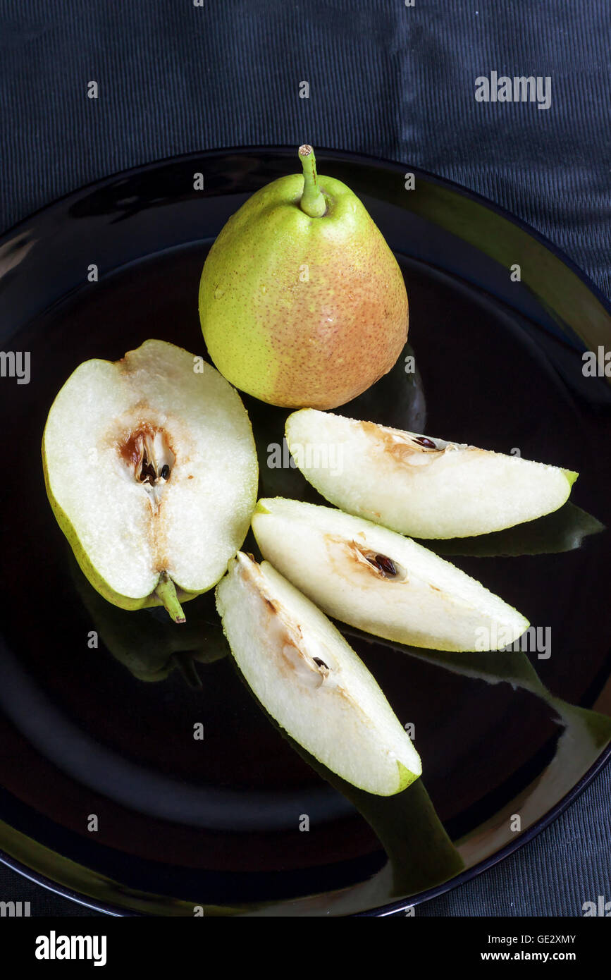 Fragrant pears . sweet fragrant flavor and aroma on black dish Stock ...