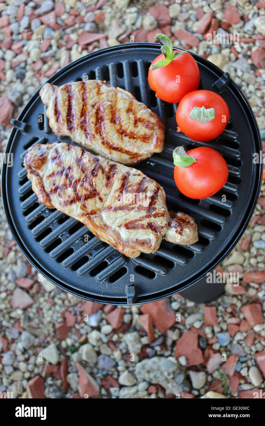 Two steaks on a barbeque Stock Photo - Alamy