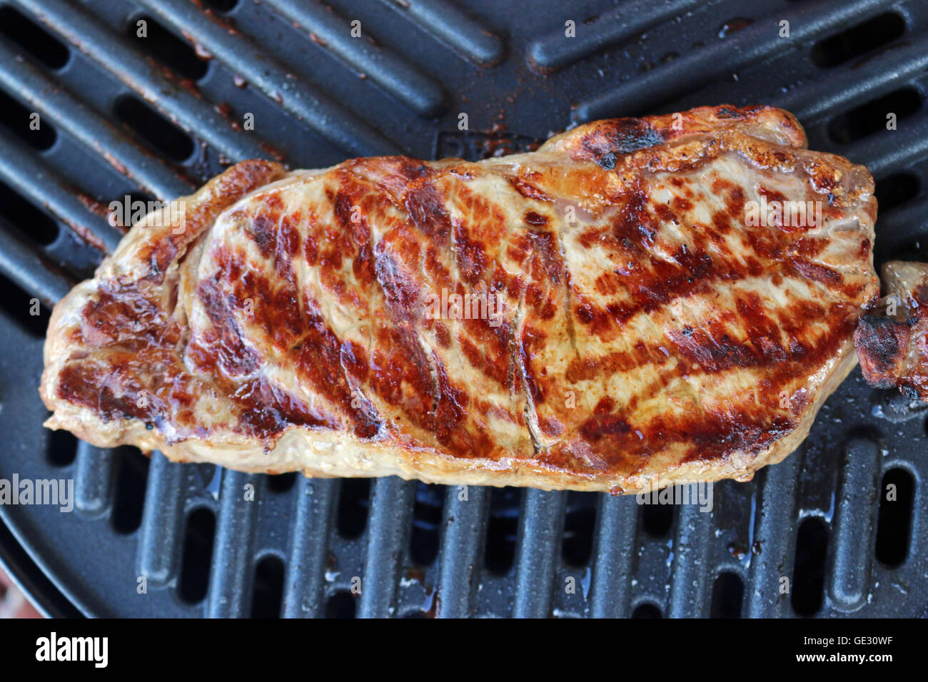 Single steak on a barbeque Stock Photo - Alamy