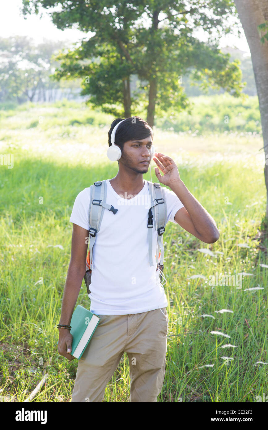 indian male college student listening to music outdoor Stock Photo - Alamy