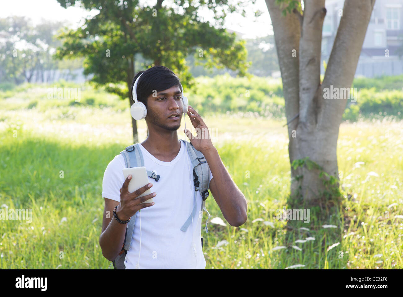 indian male college student listening to music outdoor Stock Photo - Alamy