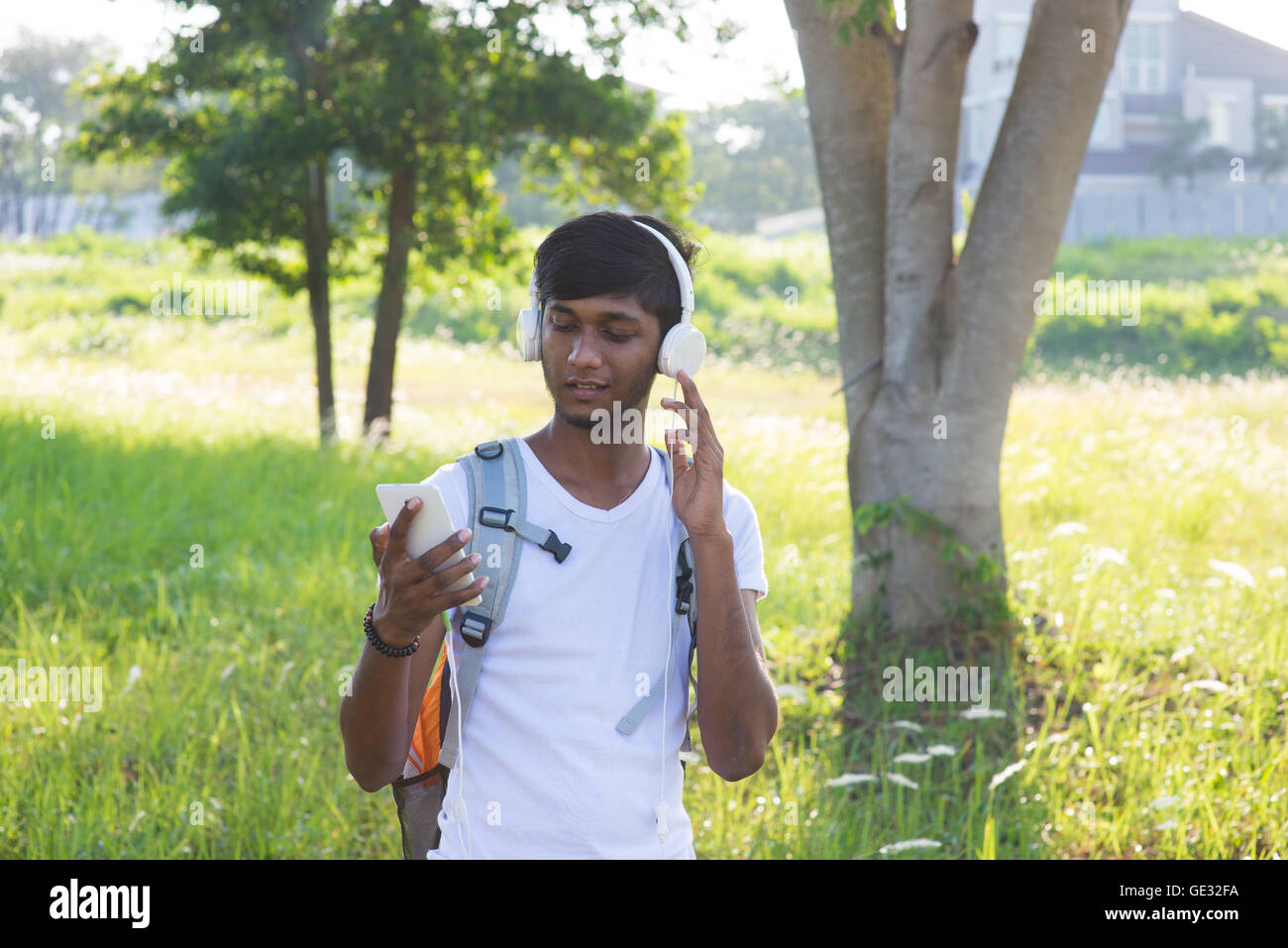 indian male college student listening to music outdoor Stock Photo - Alamy
