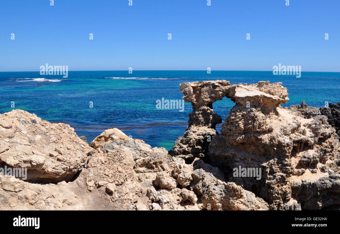 Natural rock window in the rugged limestone outcroppings at Point Peron ...