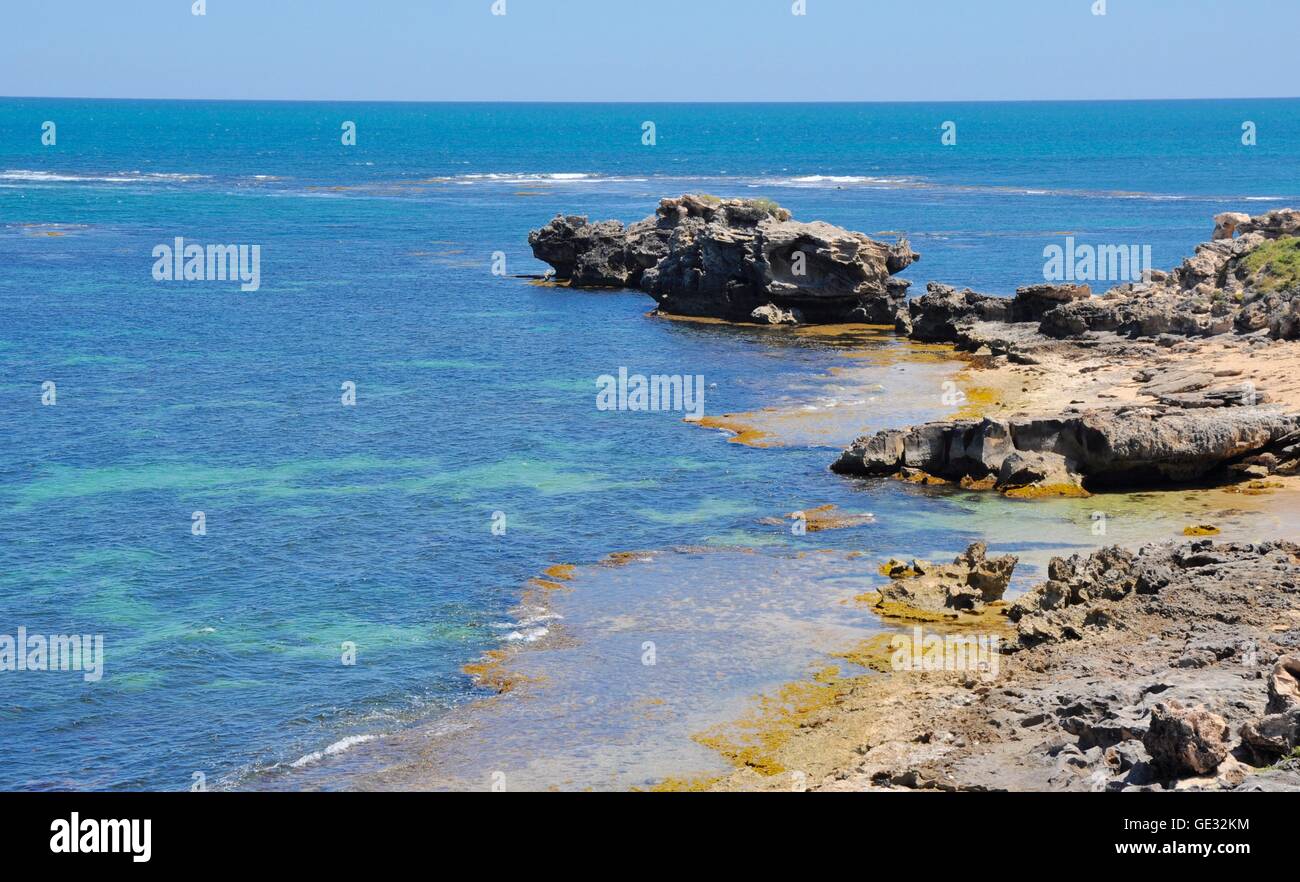 Limestone outcropping and turquoise Indian Ocean seascape with algae at ...