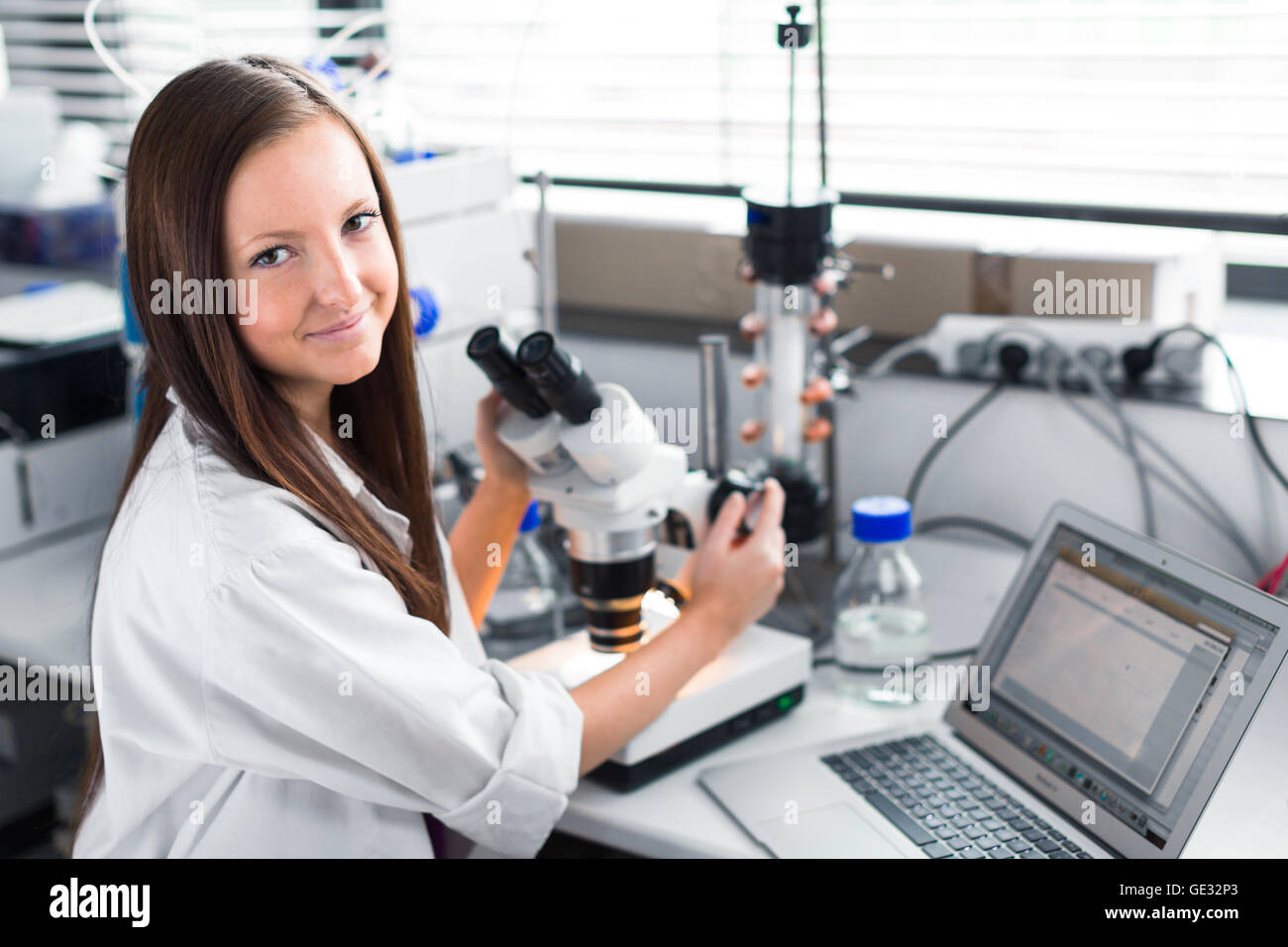 Portrait of a female chemistry student carrying out research in a ...