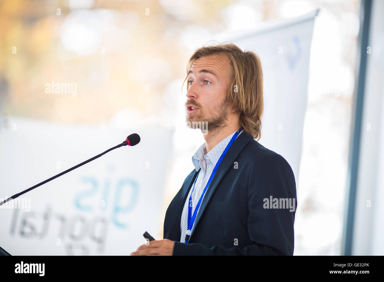 Handsome young man giving a speech at a conference Stock Photo - Alamy