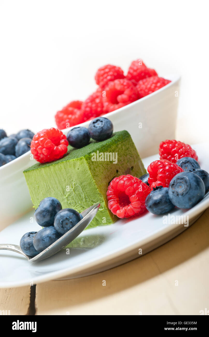 green tea matcha mousse cake with raspberries and blueberries on top ...