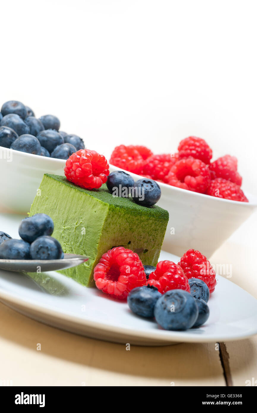 green tea matcha mousse cake with raspberries and blueberries on top ...