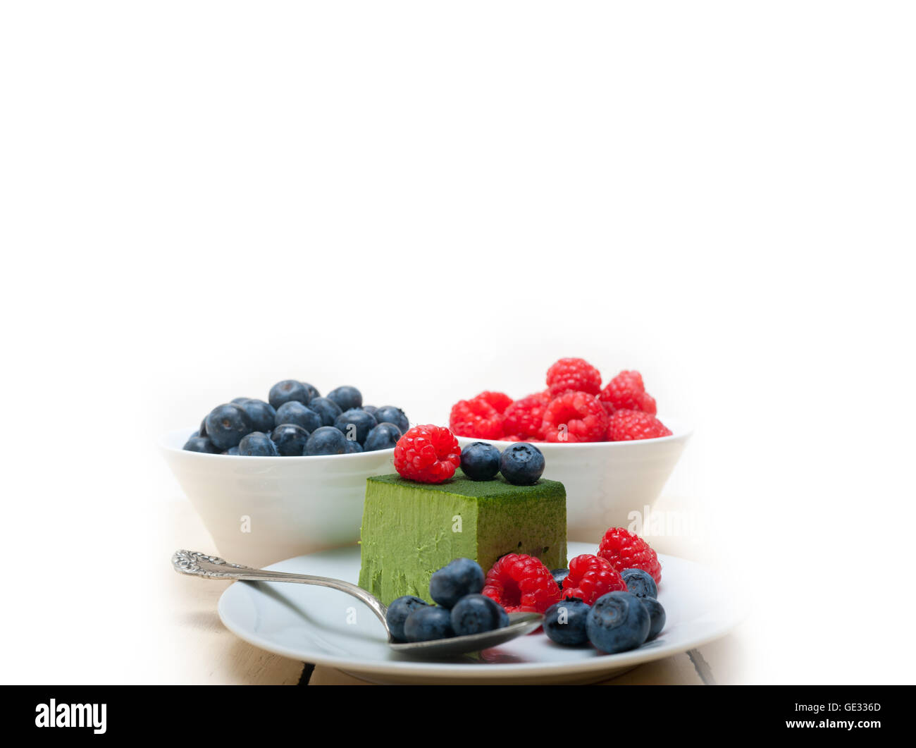 green tea matcha mousse cake with raspberries and blueberries on top ...