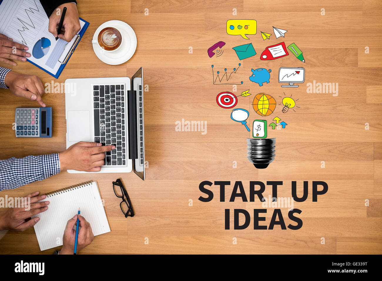 START UP IDEAS Business team hands at work with financial reports and a ...