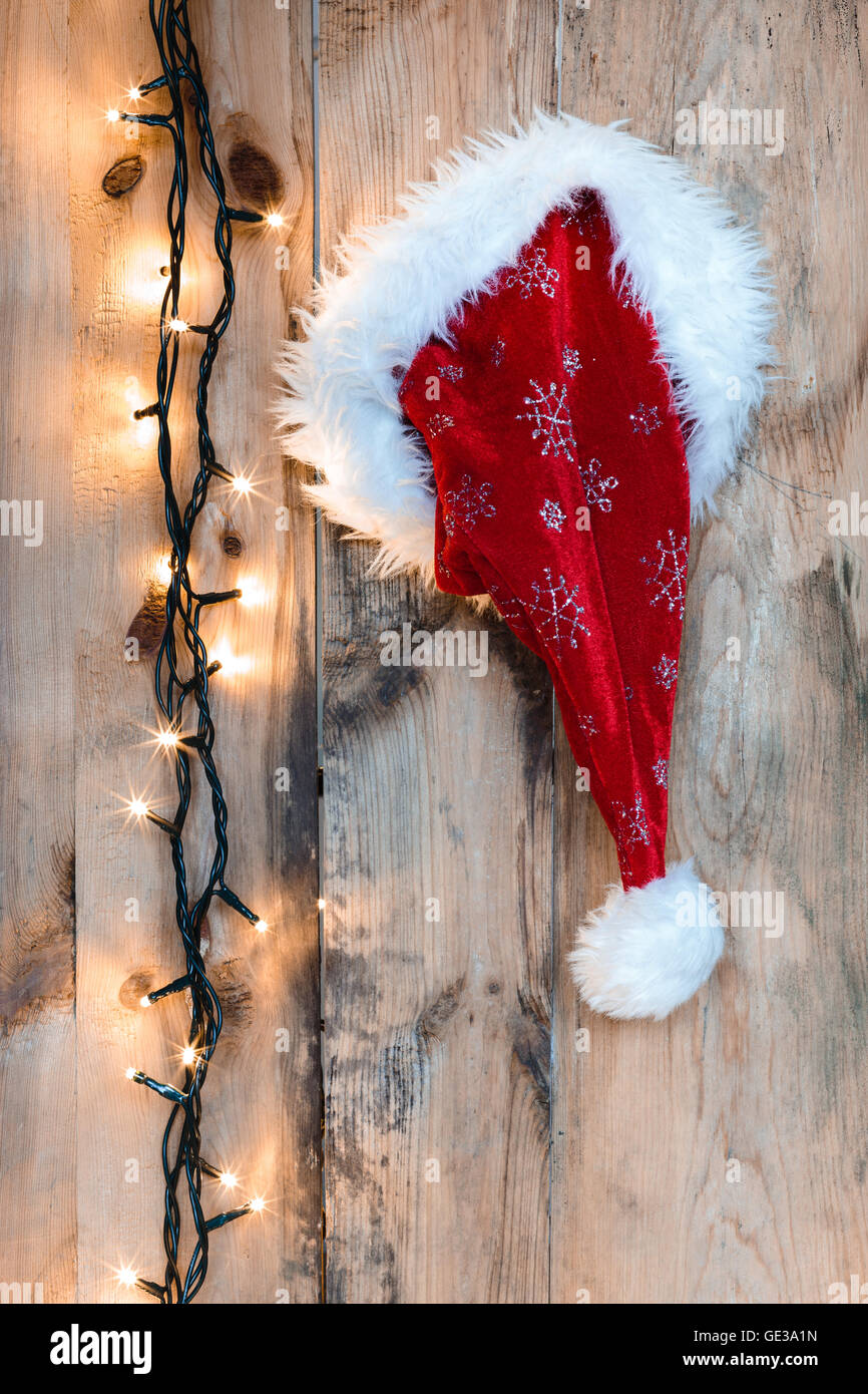 Santa Claus hat hung on a wooden wall Stock Photo - Alamy