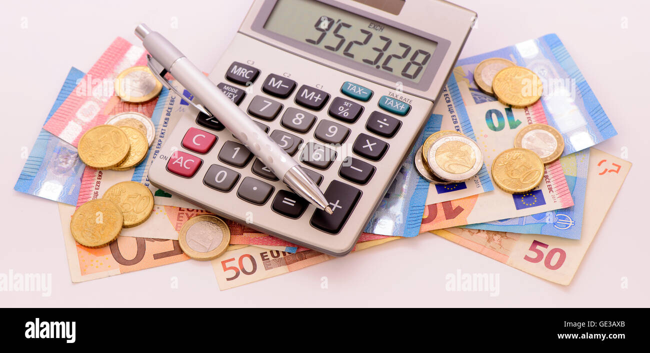Many Euro banknotes and calculator laying on table Stock Photo - Alamy