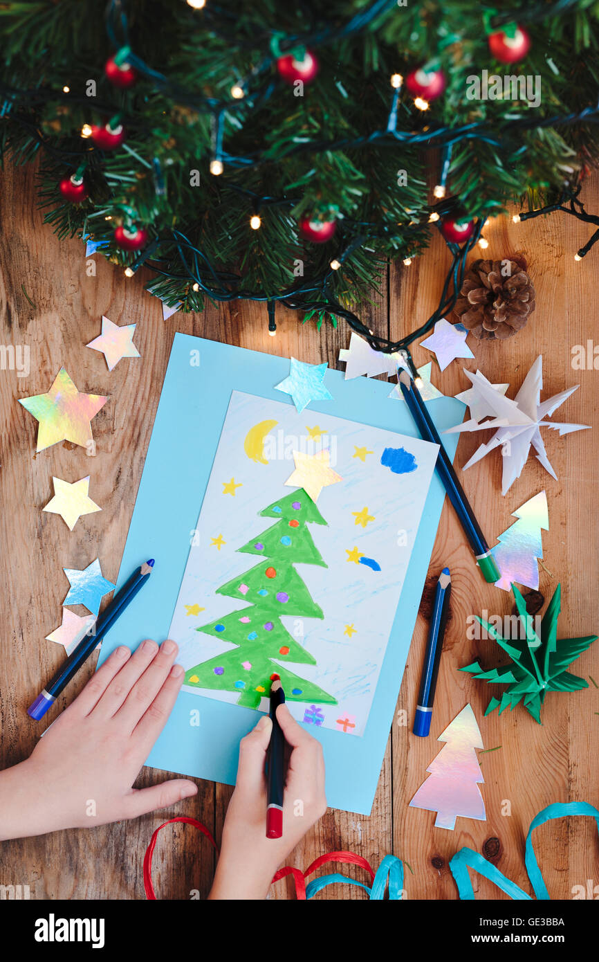 Girl drawing Christmas card with pine tree Stock Photo - Alamy