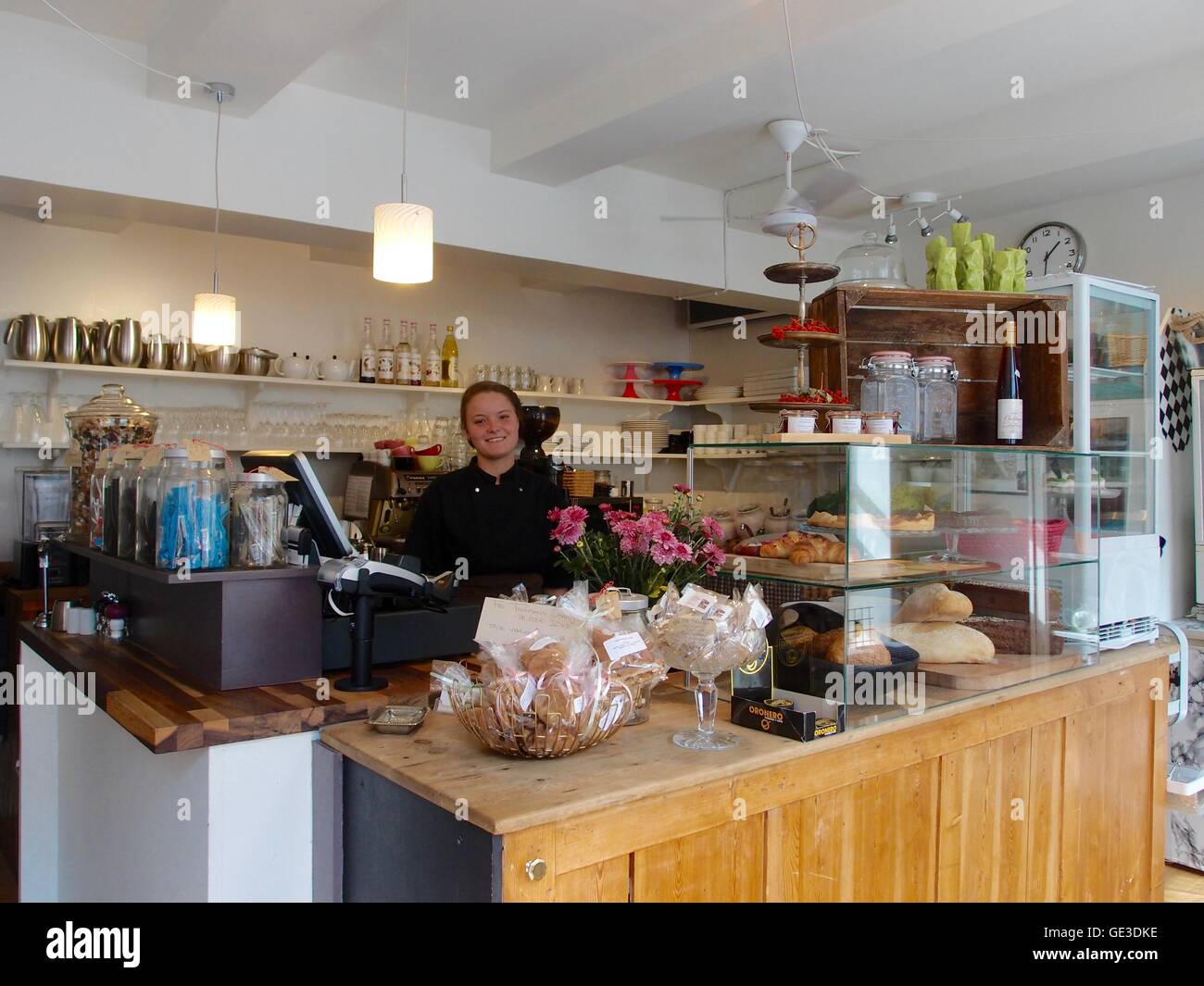 Interior of café, with young female server behind the counter Stock ...