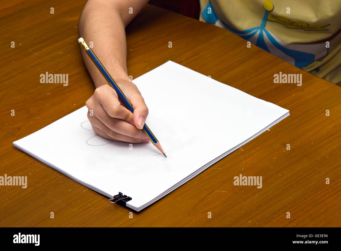 A girl is drawing something on the paper Stock Photo - Alamy