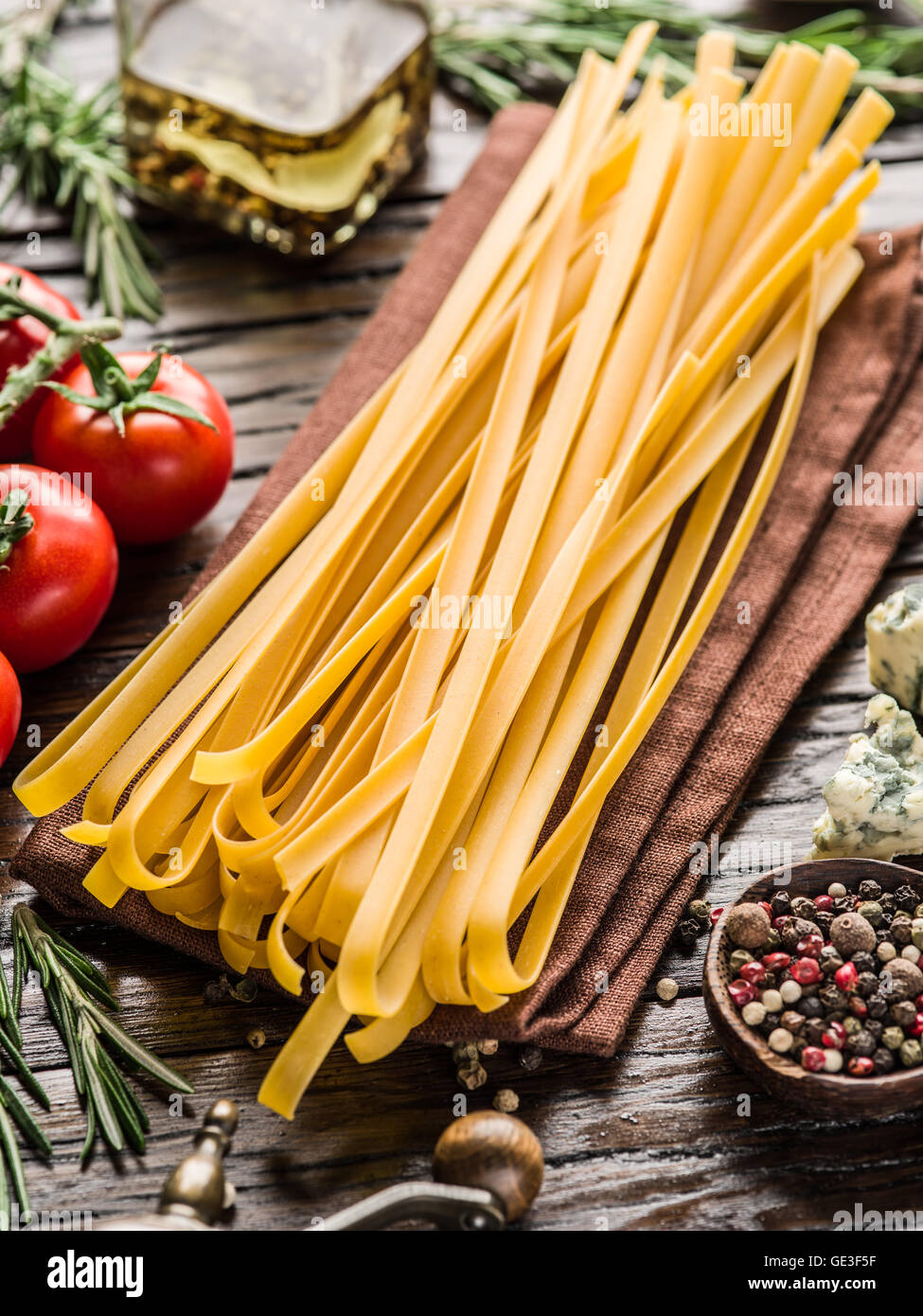 Pasta ingredients. Cherry-tomatoes, spaghetti pasta, rosemary and ...