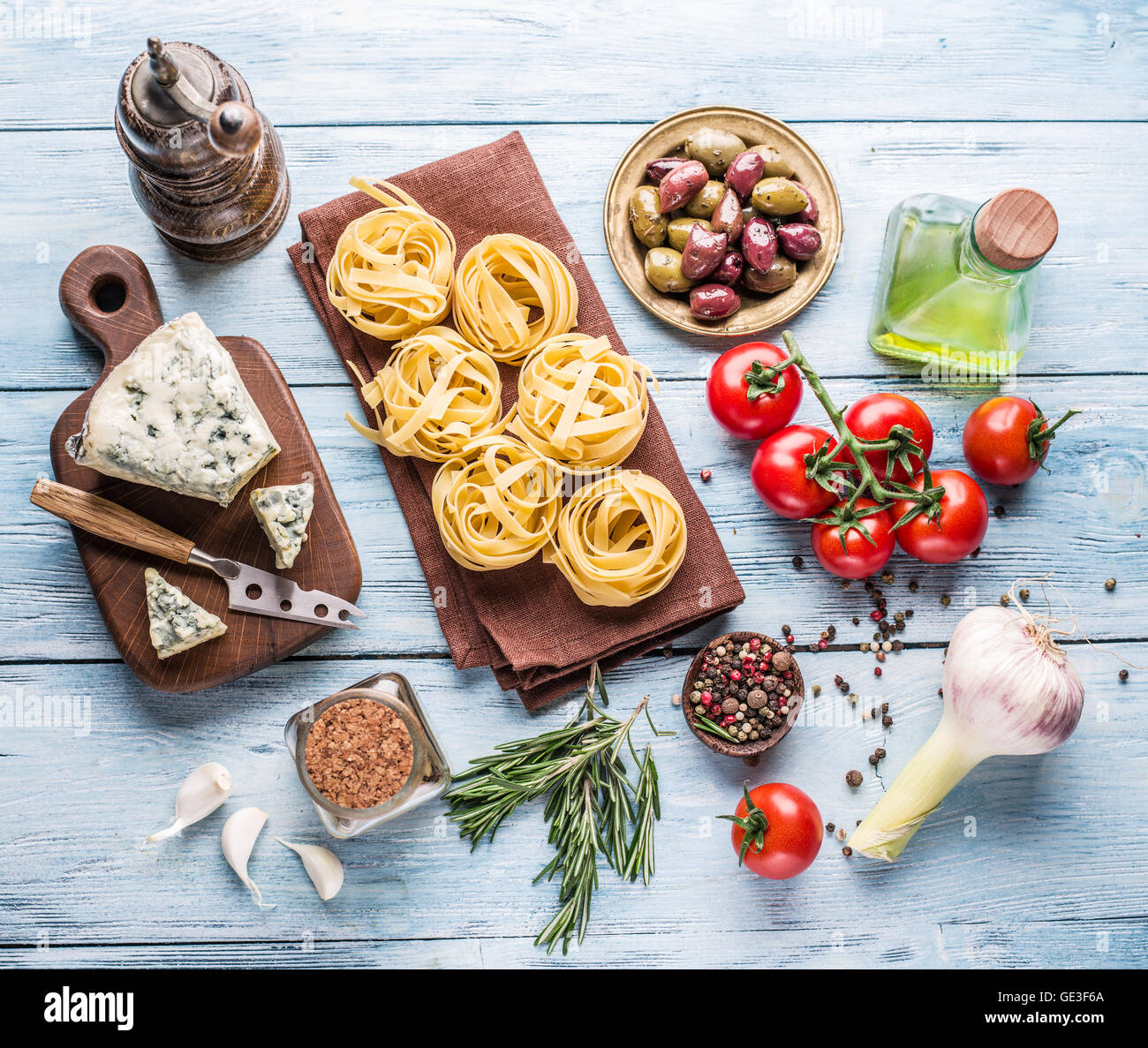 Pasta ingredients. Cherry-tomatoes, spaghetti pasta, rosemary and ...