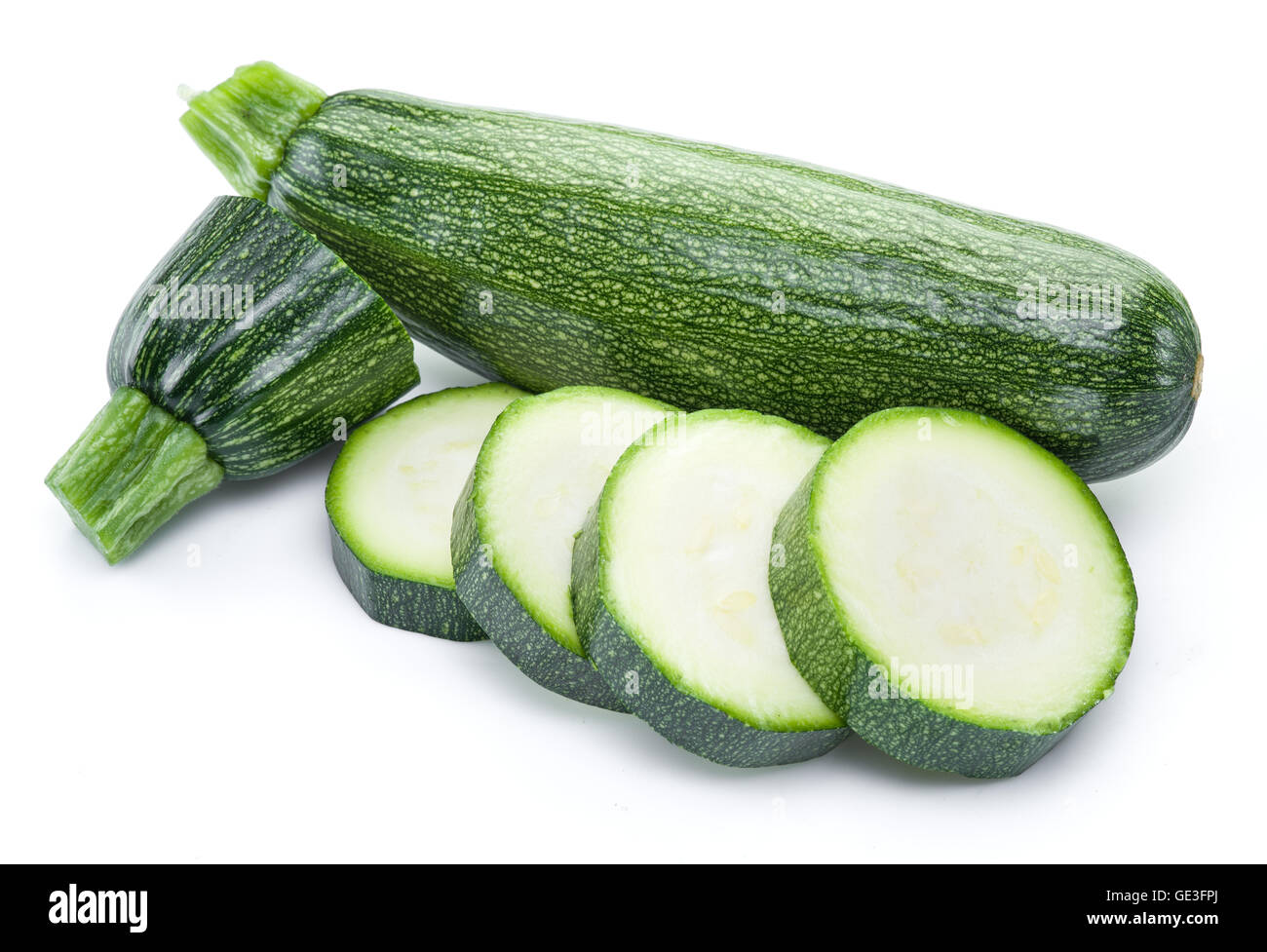 Zucchini with slices on a white background Stock Photo - Alamy
