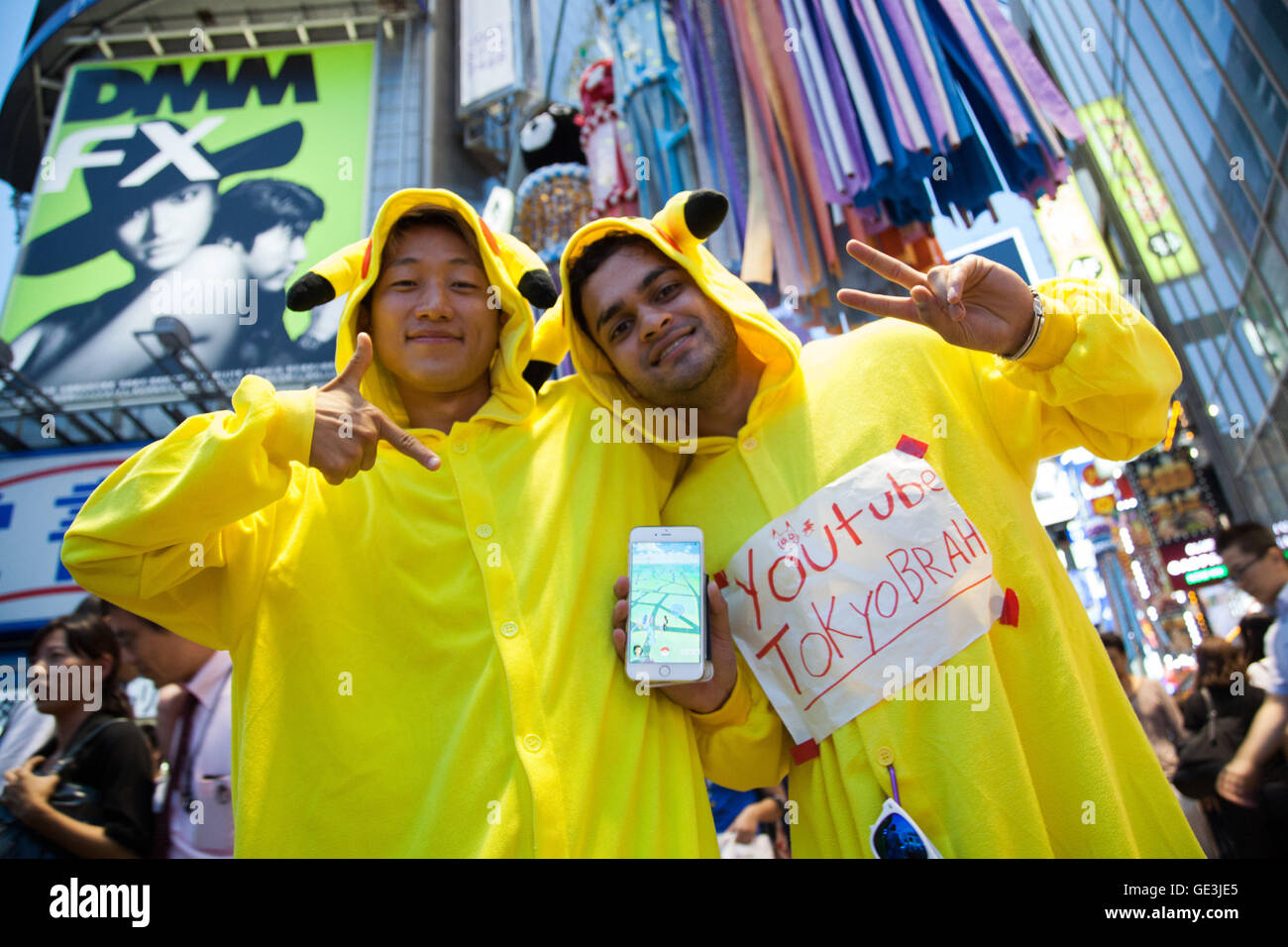 Fans try out Pokemon Go in Tokyo's Shibuya district on July 22, 2016 ...