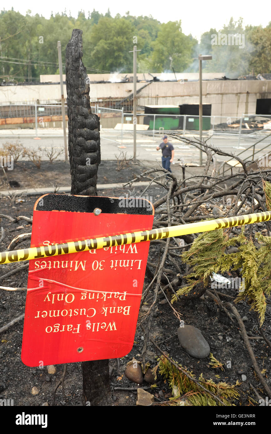 Bothell, USA. 22nd Jul, 2016. A firefighter walks along the charred ...
