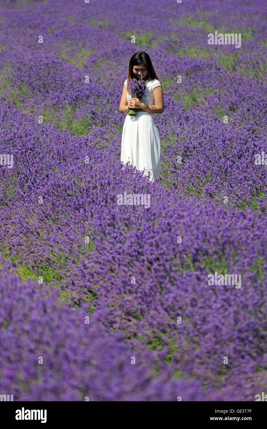 Banstead, Surrey, UK. 23rd July 2016. A woman in white poses in the ...