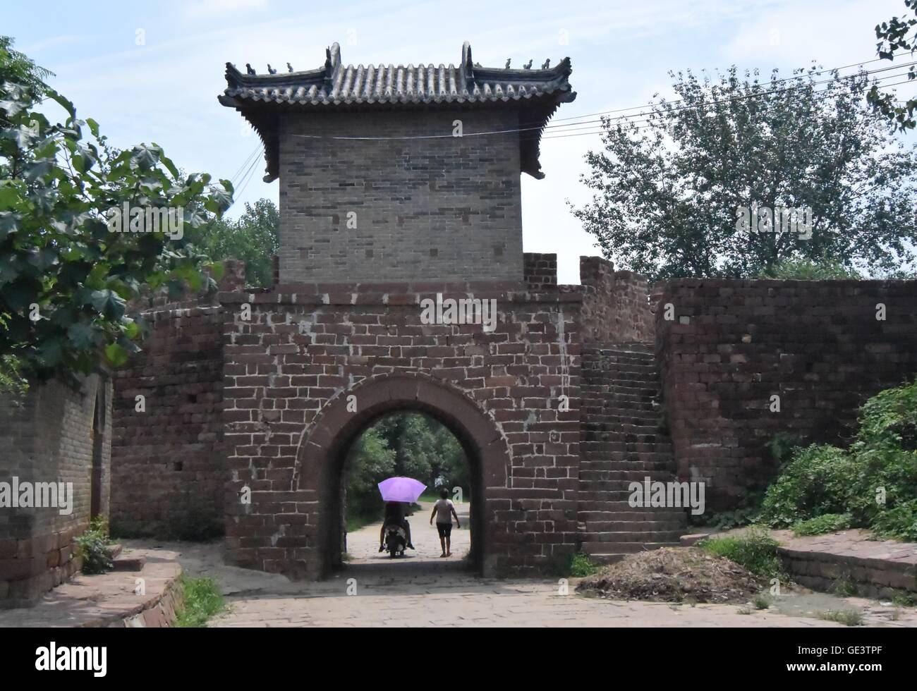 Pingdingshan, China's Henan Province. 23rd July, 2016. Villagers pass ...