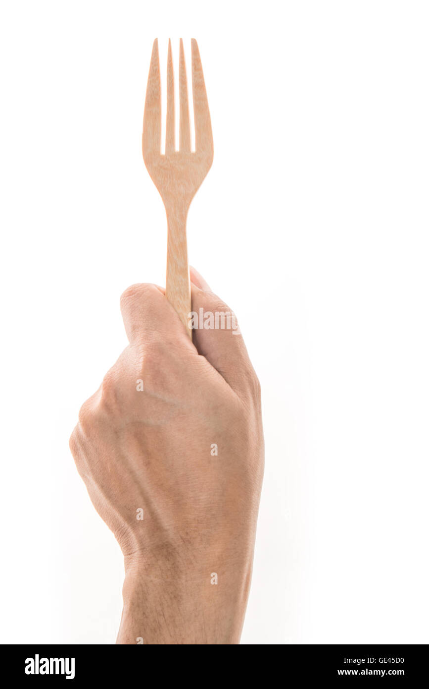Men hand holding wooden fork on white background Stock Photo - Alamy