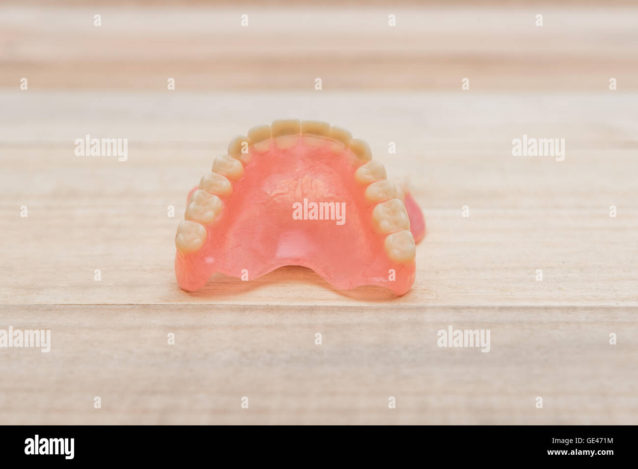 Close-up Dentures on wooden table Stock Photo - Alamy