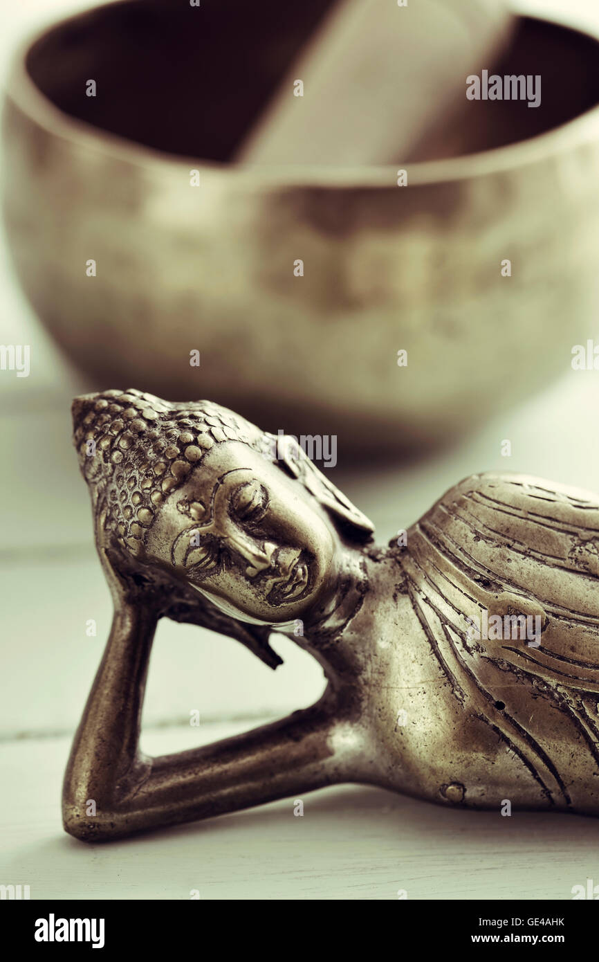 closeup of a representation of the buddha laying down, on a pale green ...