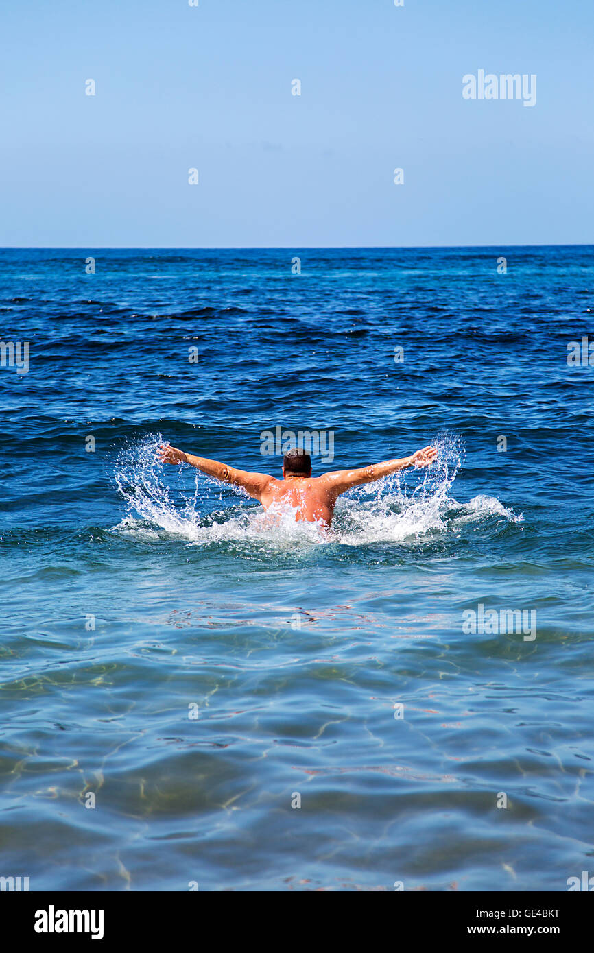 A muscular man swims in the water of sea Stock Photo - Alamy