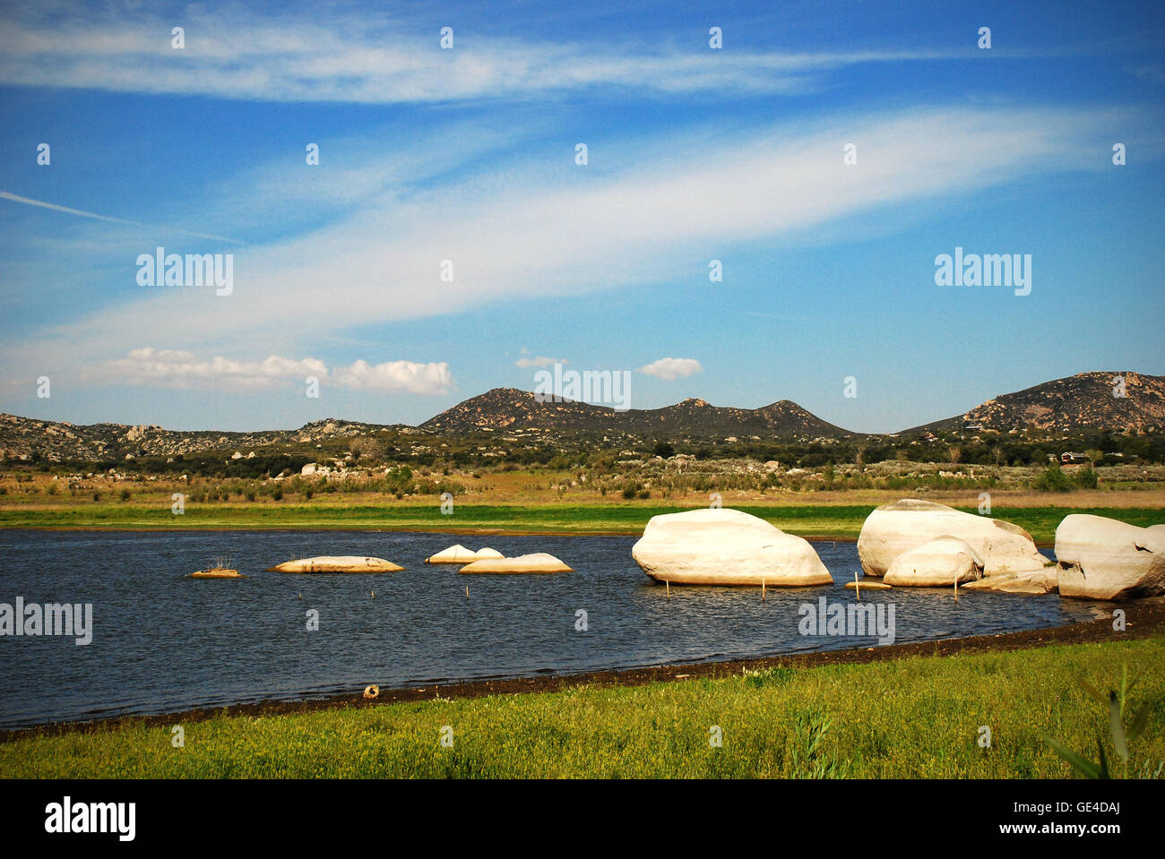 Rocks in Lake Morena with sky and mountains Stock Photo - Alamy