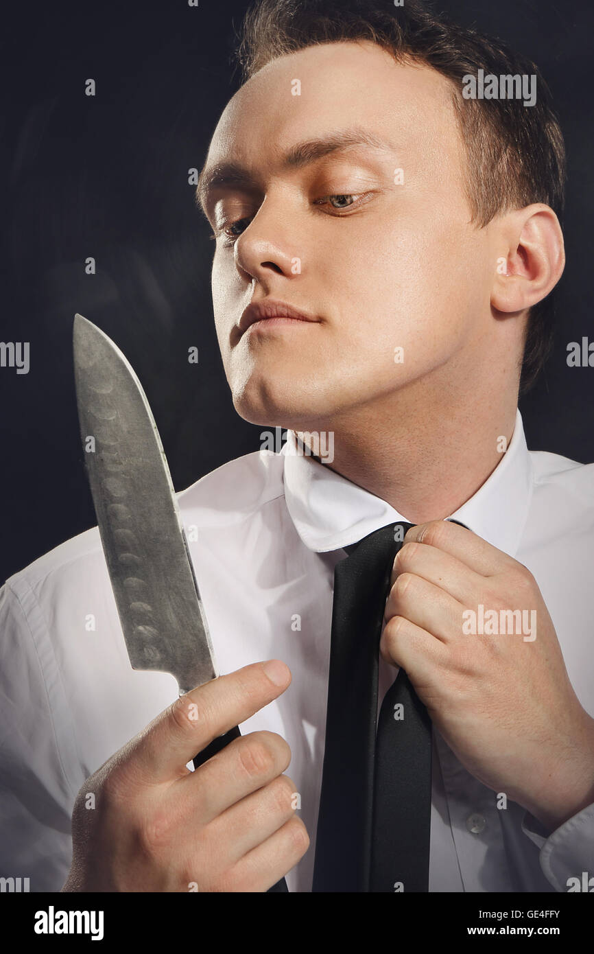 Handsome young man in a white shirt elegant browsing the blade cleaver ...