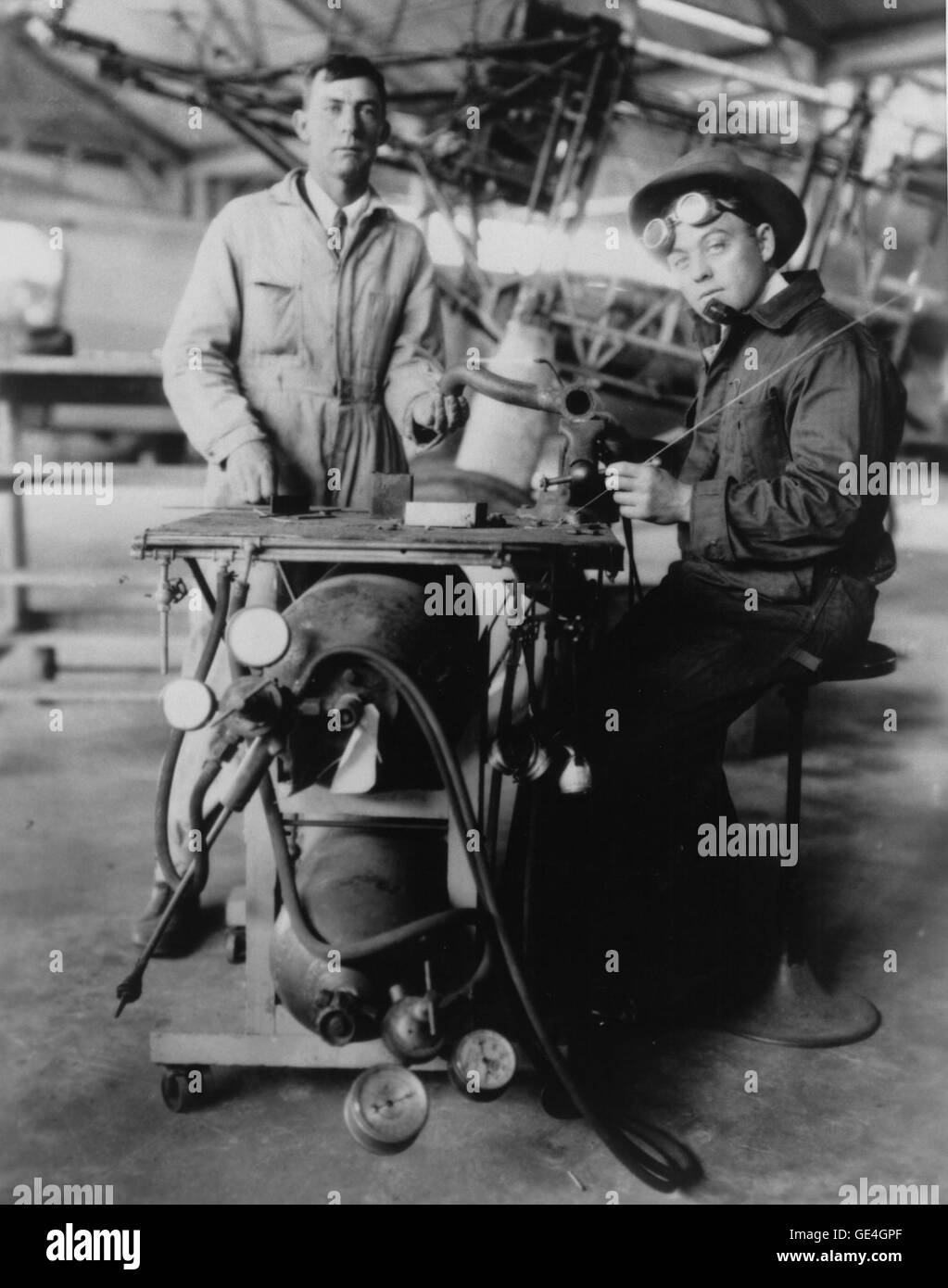 Metal workers are shown at work, shaping materials for spacecraft ...