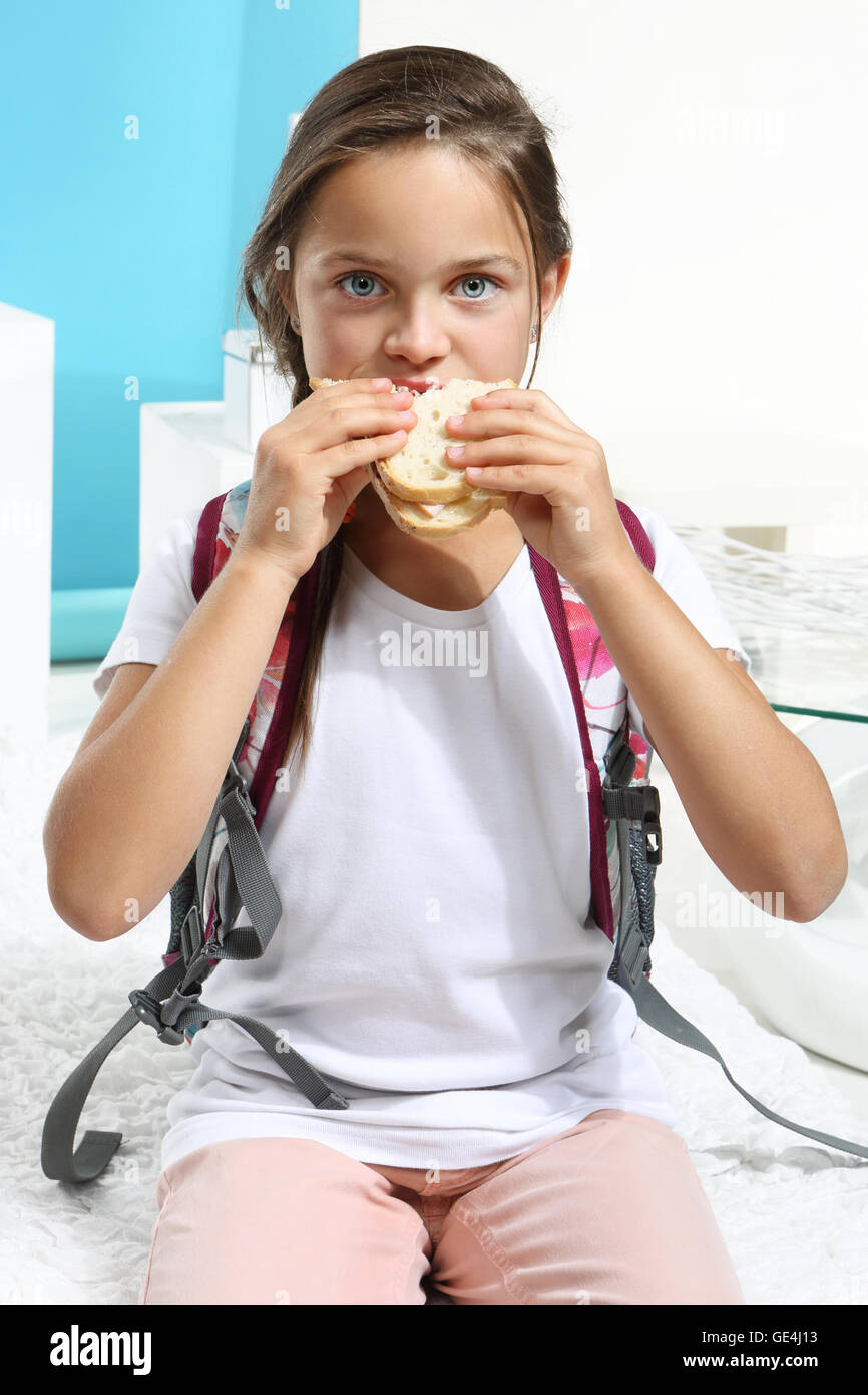 School girl eating a sandwich Stock Photo - Alamy