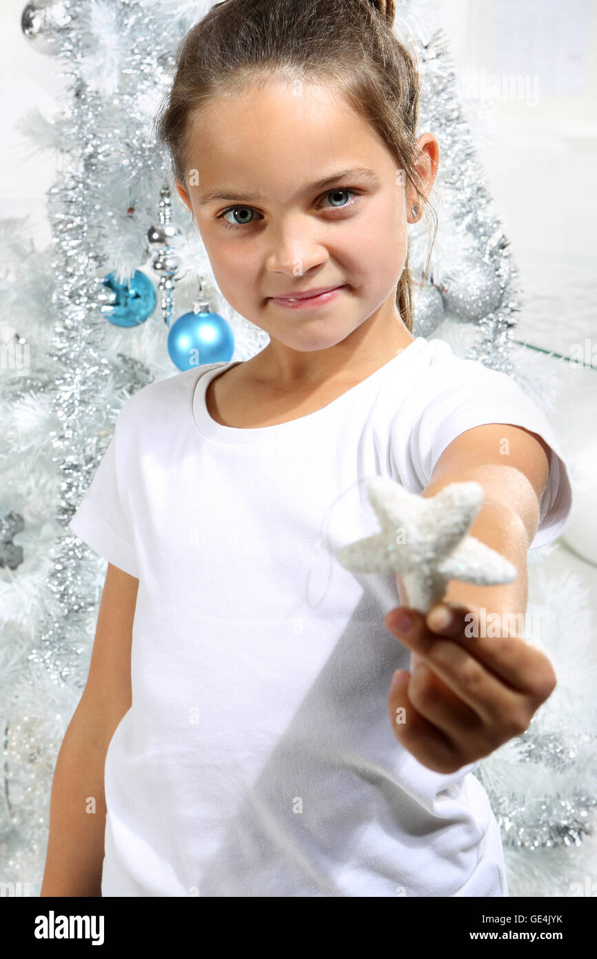 Girl with Christmas star Stock Photo - Alamy