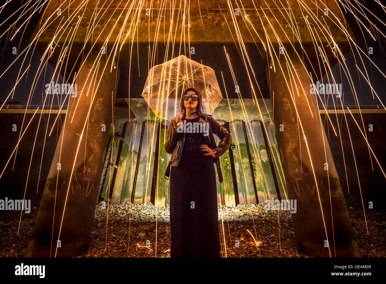 Raining Fire - urban scene with model and umbrella Stock Photo - Alamy