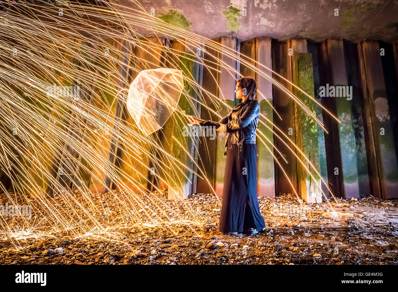 Raining Fire - urban scene with model and umbrella Stock Photo - Alamy