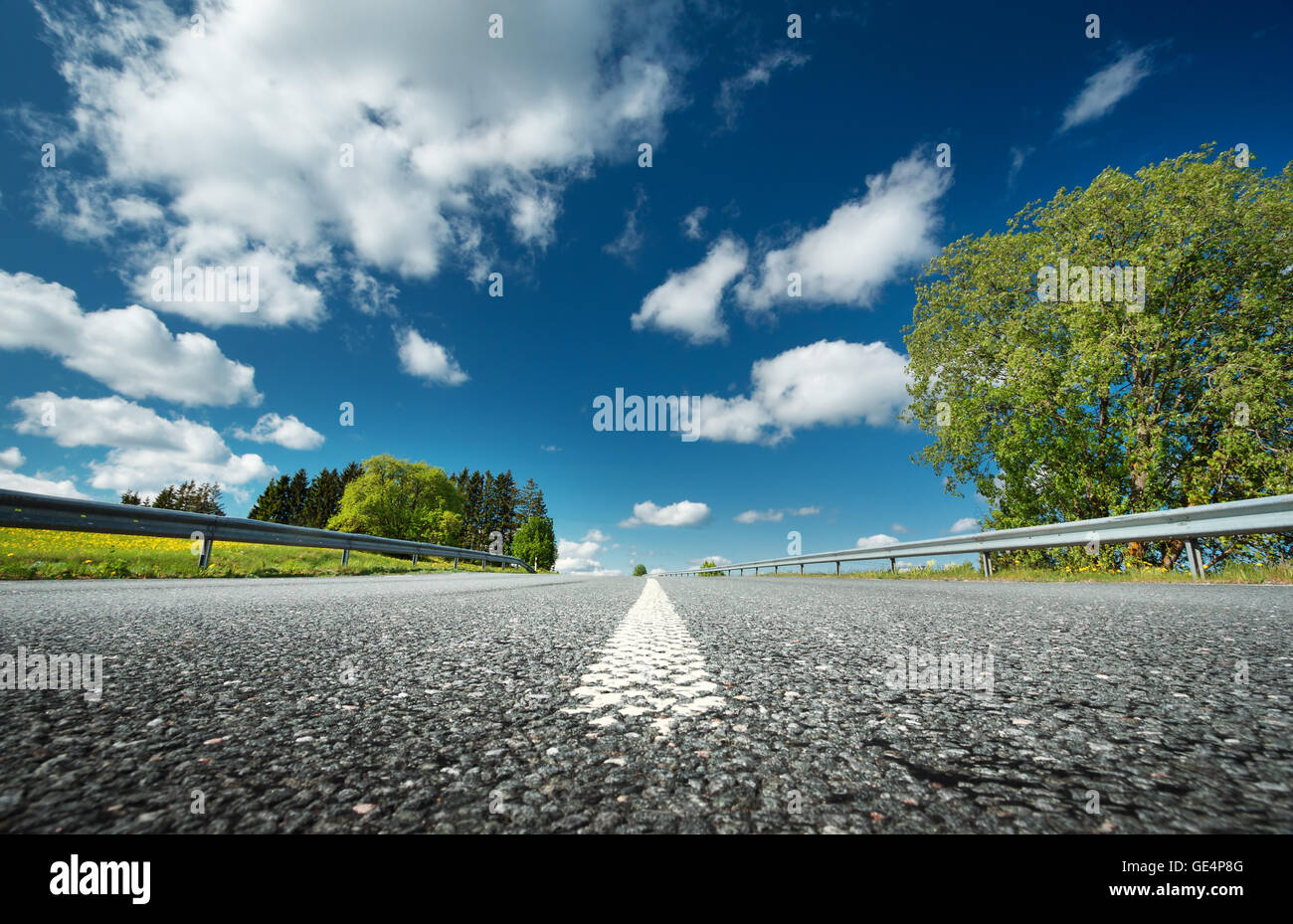 Car on asphalt road in beautiful spring day Stock Photo - Alamy