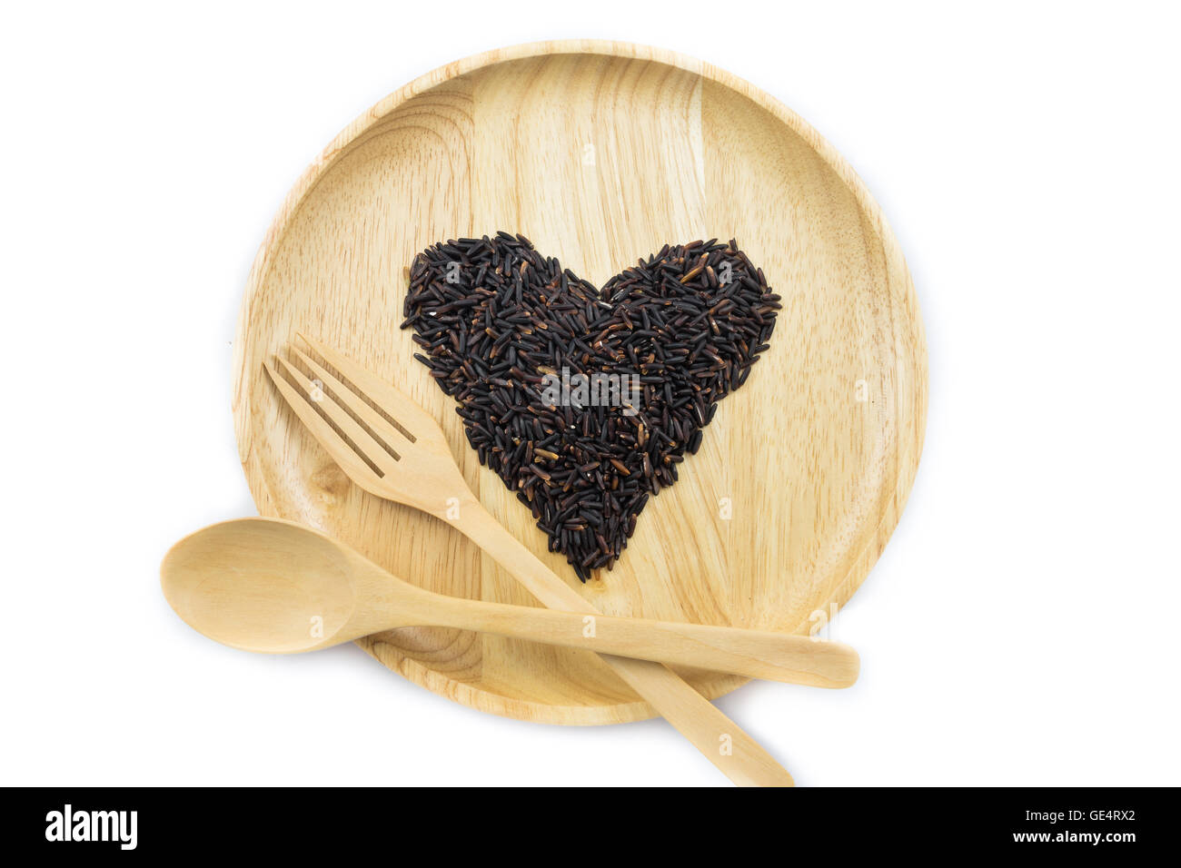 Heart rice berry in wooden bowls with spoon and forkon white background ...