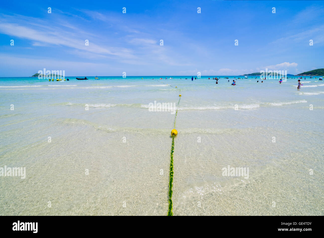 Surfer on Pretty beach and ocean with blue sky Stock Photo - Alamy