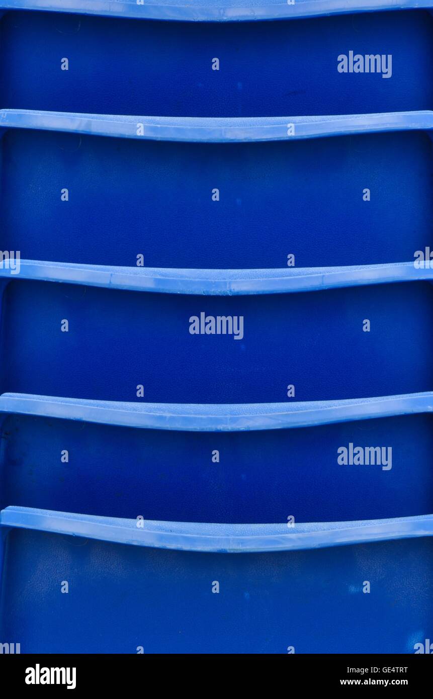 Abstract color of bright blue stacked plastic chairs with horizontal ...